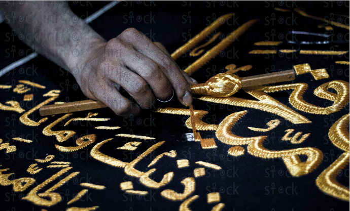 A man writing in Arabic calligraphy - stock image | Jini Stock