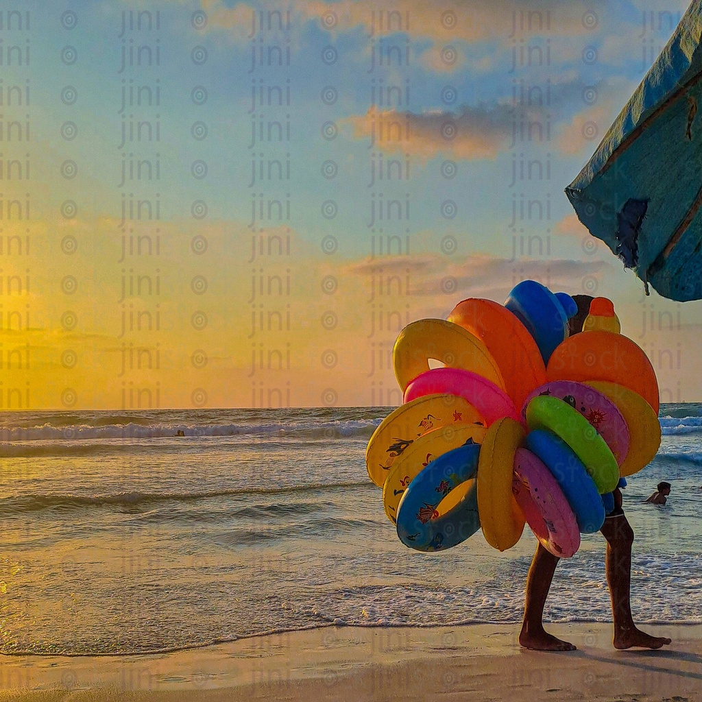 Floats seller in Alexandria beach and holding colourful water floaters ...