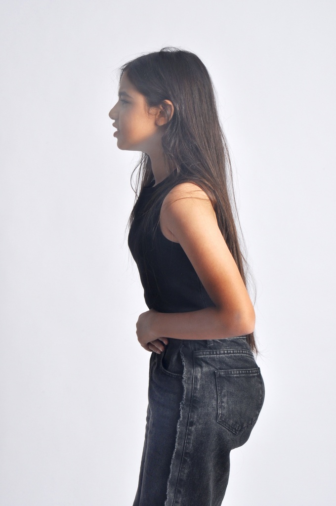 A teen girl has a pain in her stomach side view | Jini Stock