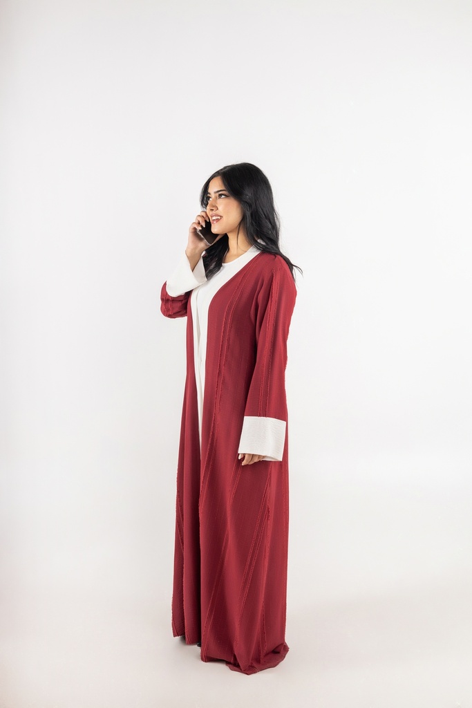 a khaliji woman wearing a long red dress and talking on the phone stock ...