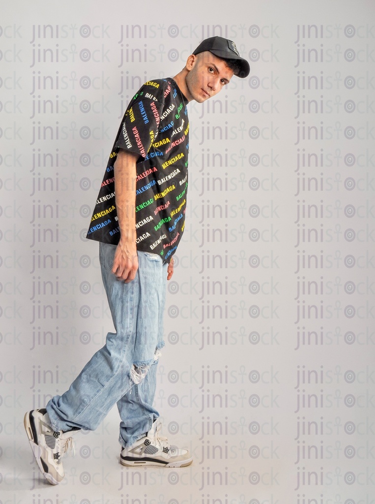 A cool man walking side view. | Jini Stock