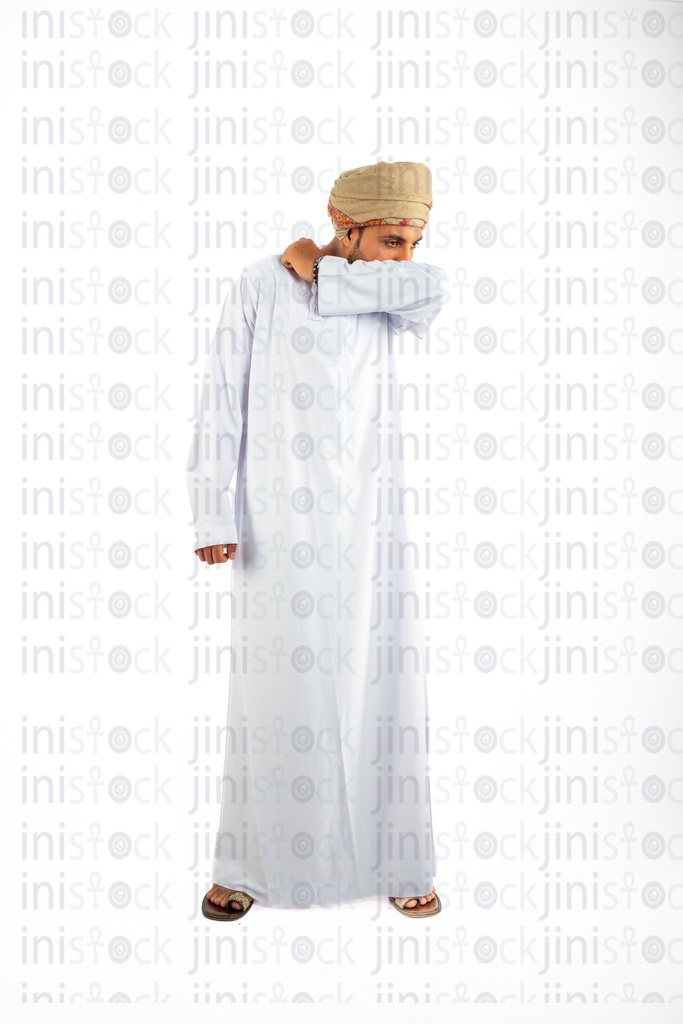 Omani arab khaliji man from gulf sneezing in his elbow | Jini Stock