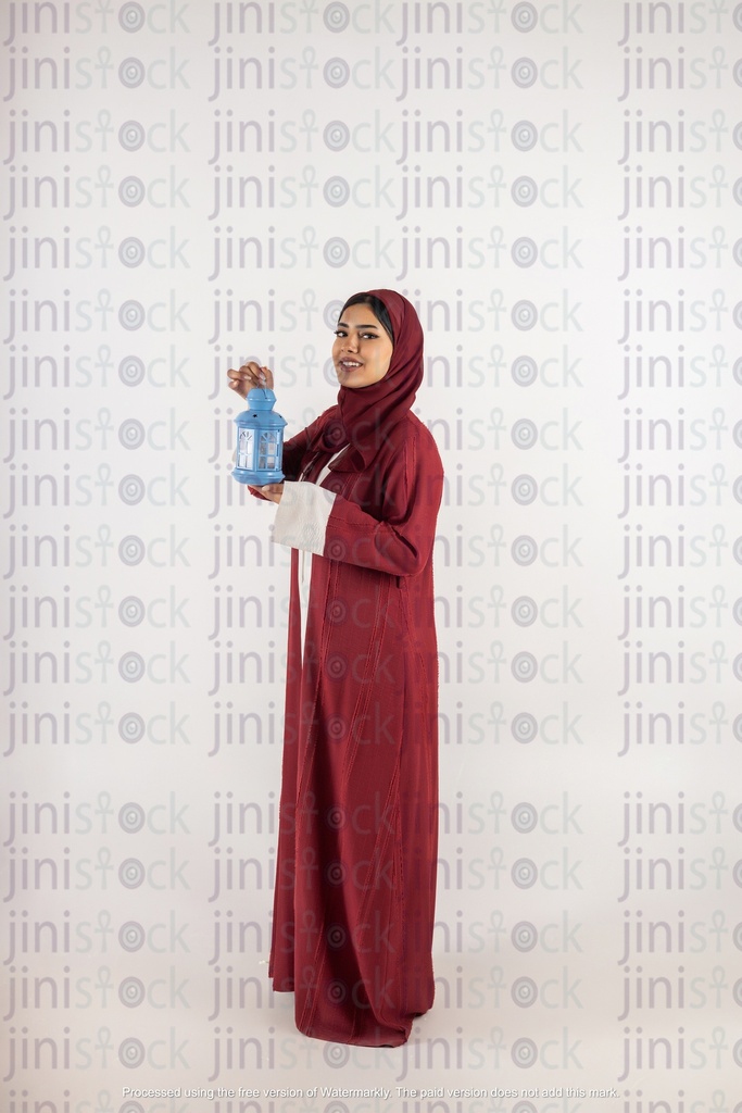 a stock image of a khaliji woman carrying Ramadan lantern on isolated ...