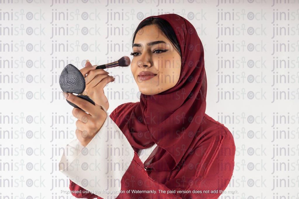 a stock image of a khaliji woman doing makeup on isolated background ...