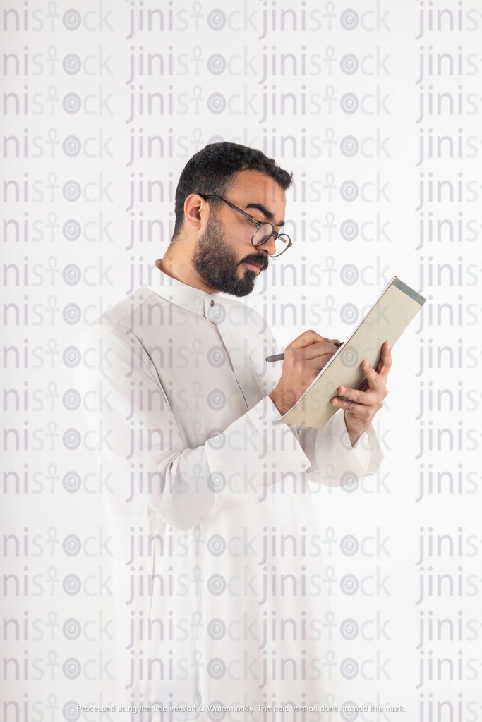 a stock image of a khaliji saudi gulf business man writing on papers ...
