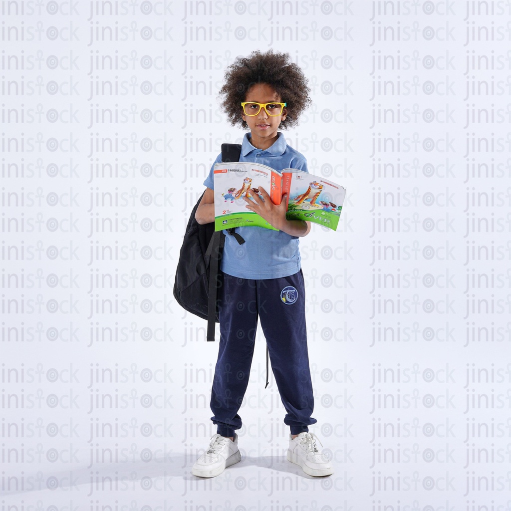 Egyptian boy wearing school uniform and carrying his bag and holding a ...