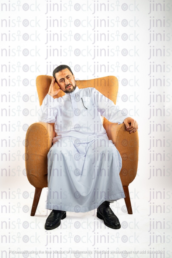 saudi khaliji man sitting on the chair tired and with headache | Jini Stock
